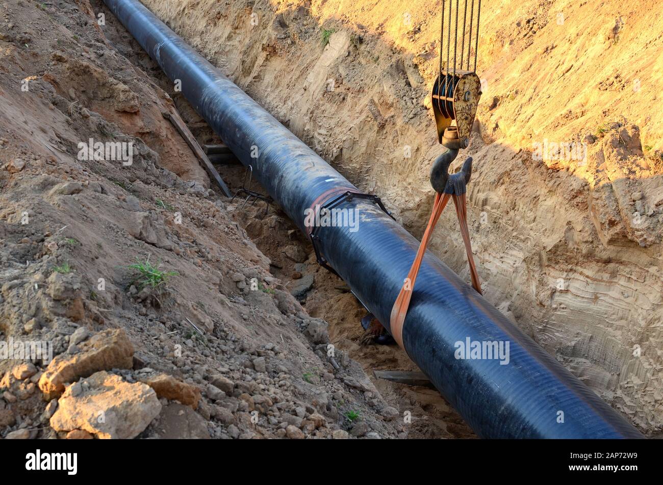 Natural gas pipeline construction work. A dug trench in the ground for ...