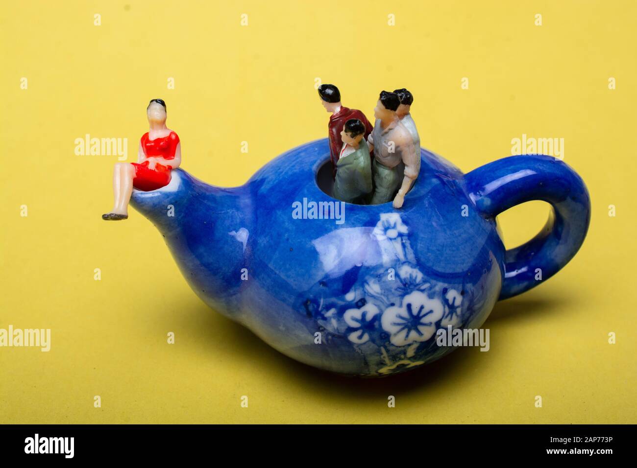Miniature people business team standing in teapot as business concept ...