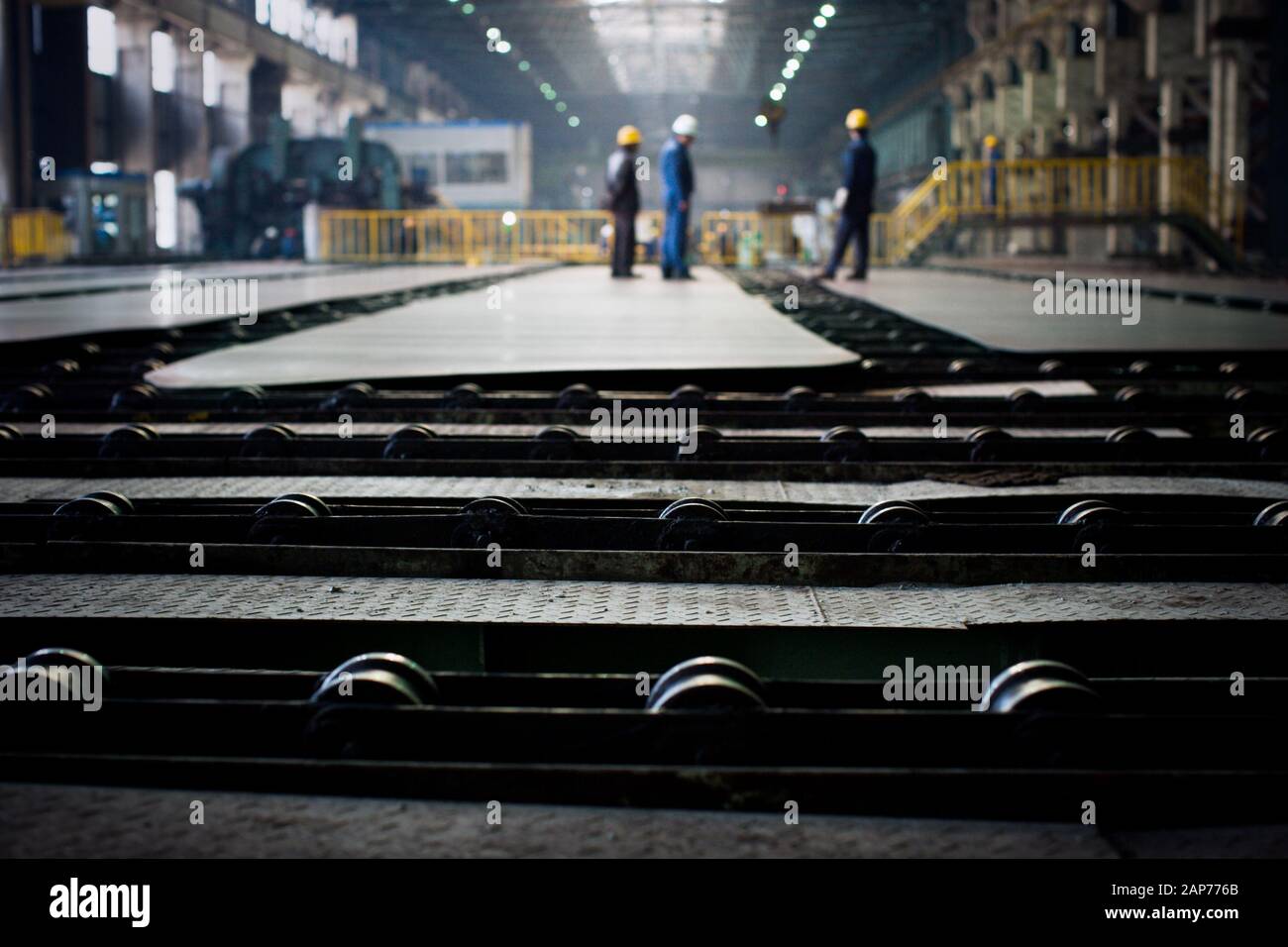 Three construction workers working in a warehouse Stock Photo - Alamy