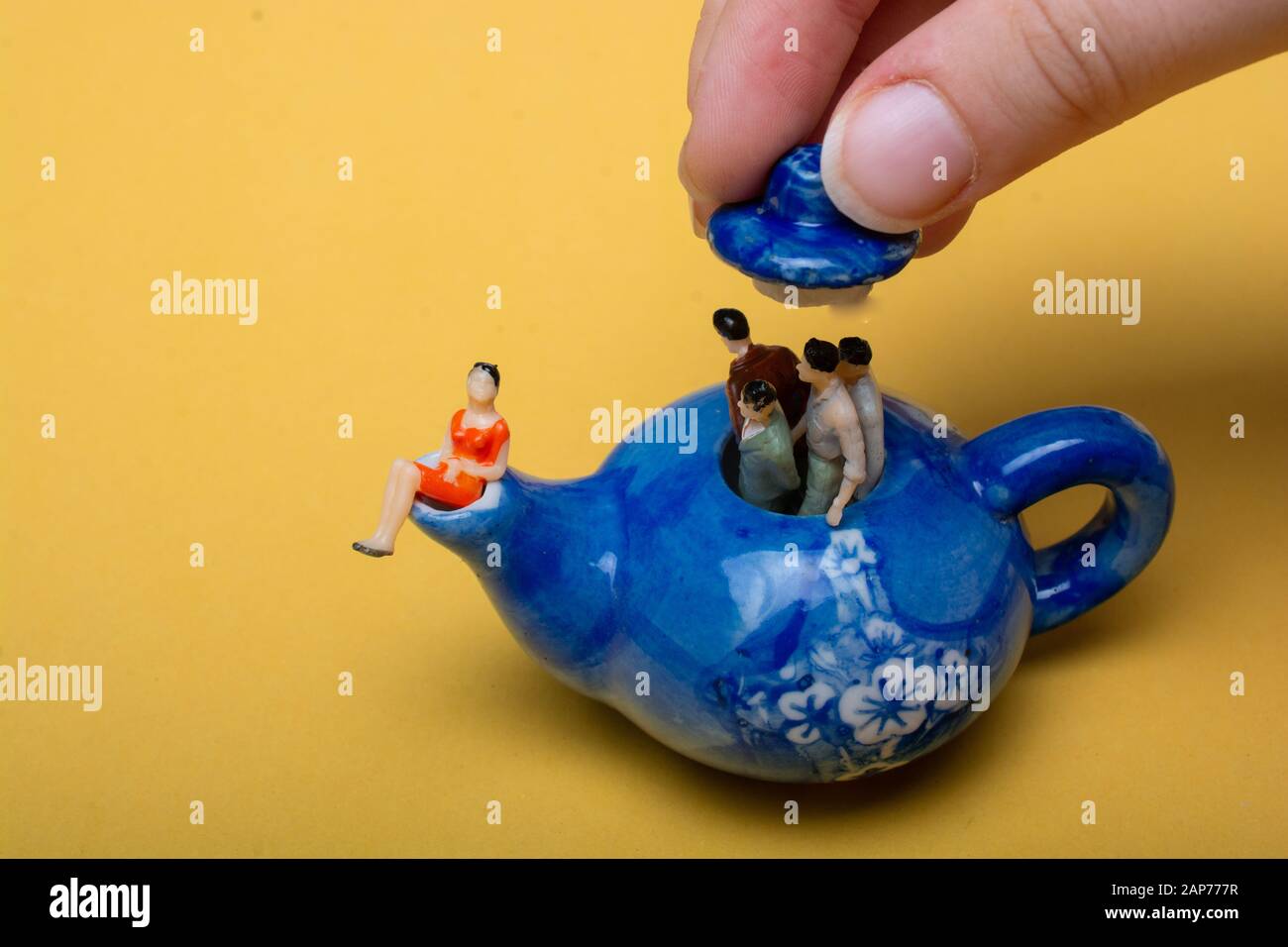 Miniature people business team standing in teapot as business concept ...