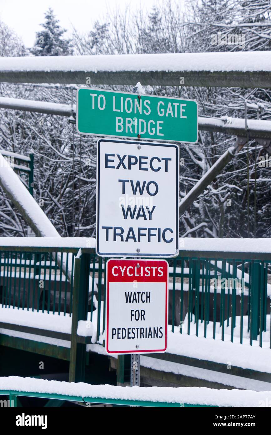 Close up View of road signs "To lions Gate bridge", "Expect two way ...