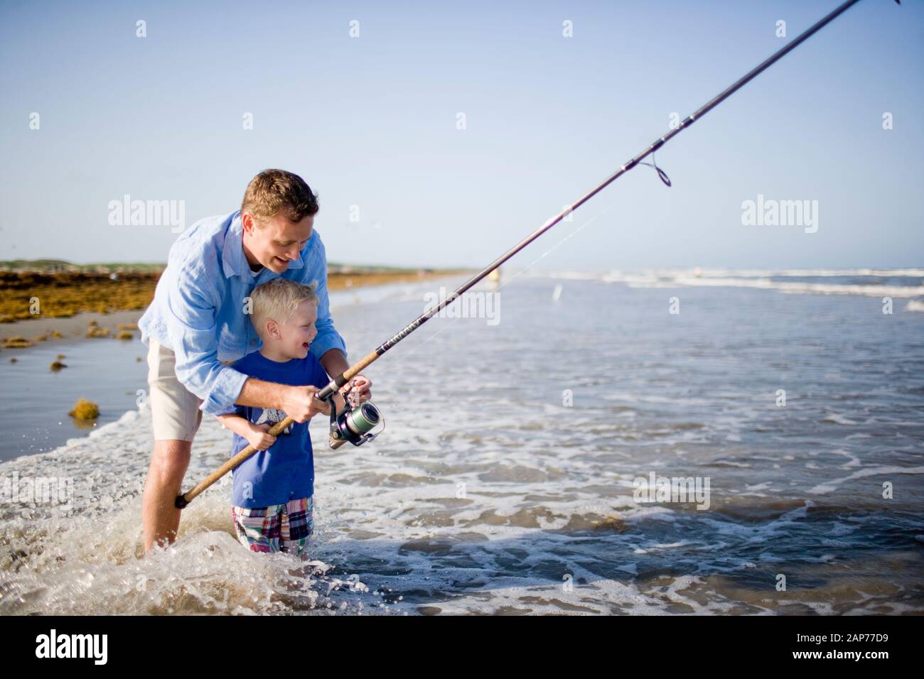 Adult teaching kids to fish hi-res stock photography and images - Alamy