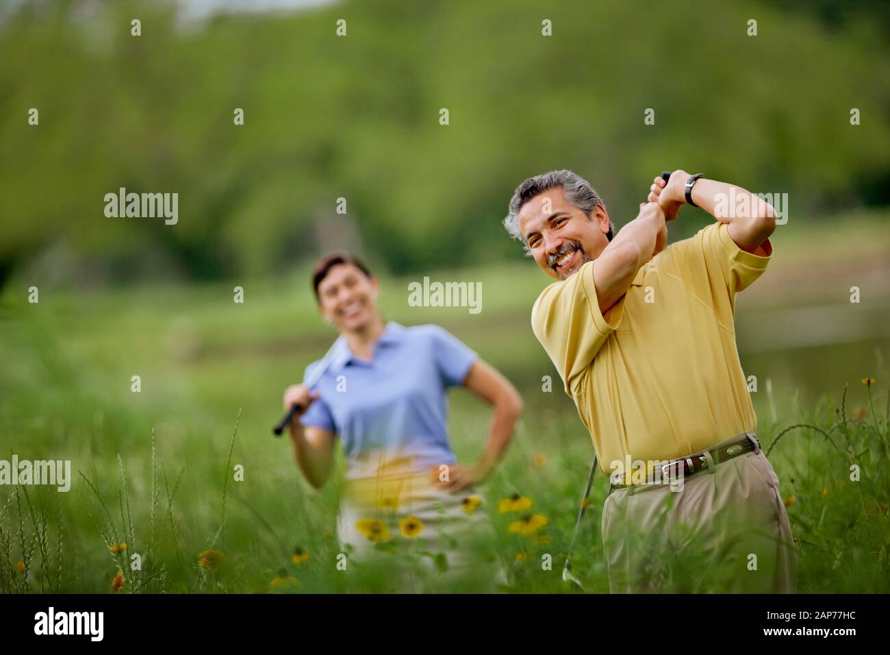 Smiling mature couple have fun playing golf together Stock Photo - Alamy