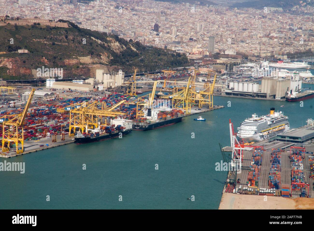 Barcelona harbor, commercial pier boats and cranes working aerial view ...