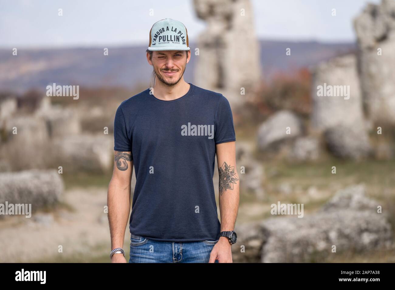 Men smiling with a hat in europe french text Stock Photo - Alamy