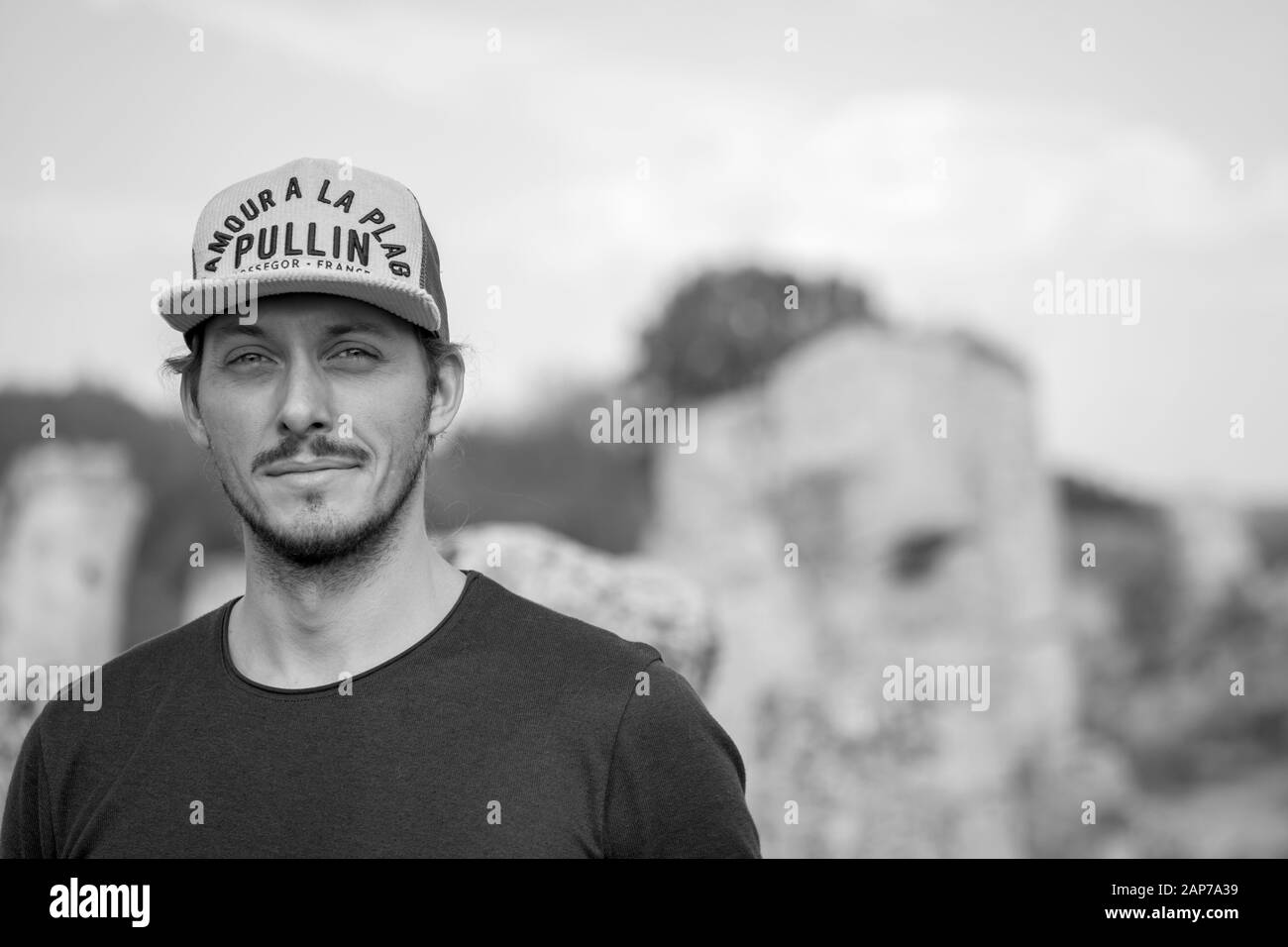 Men smiling with a hat in europe french text Stock Photo - Alamy