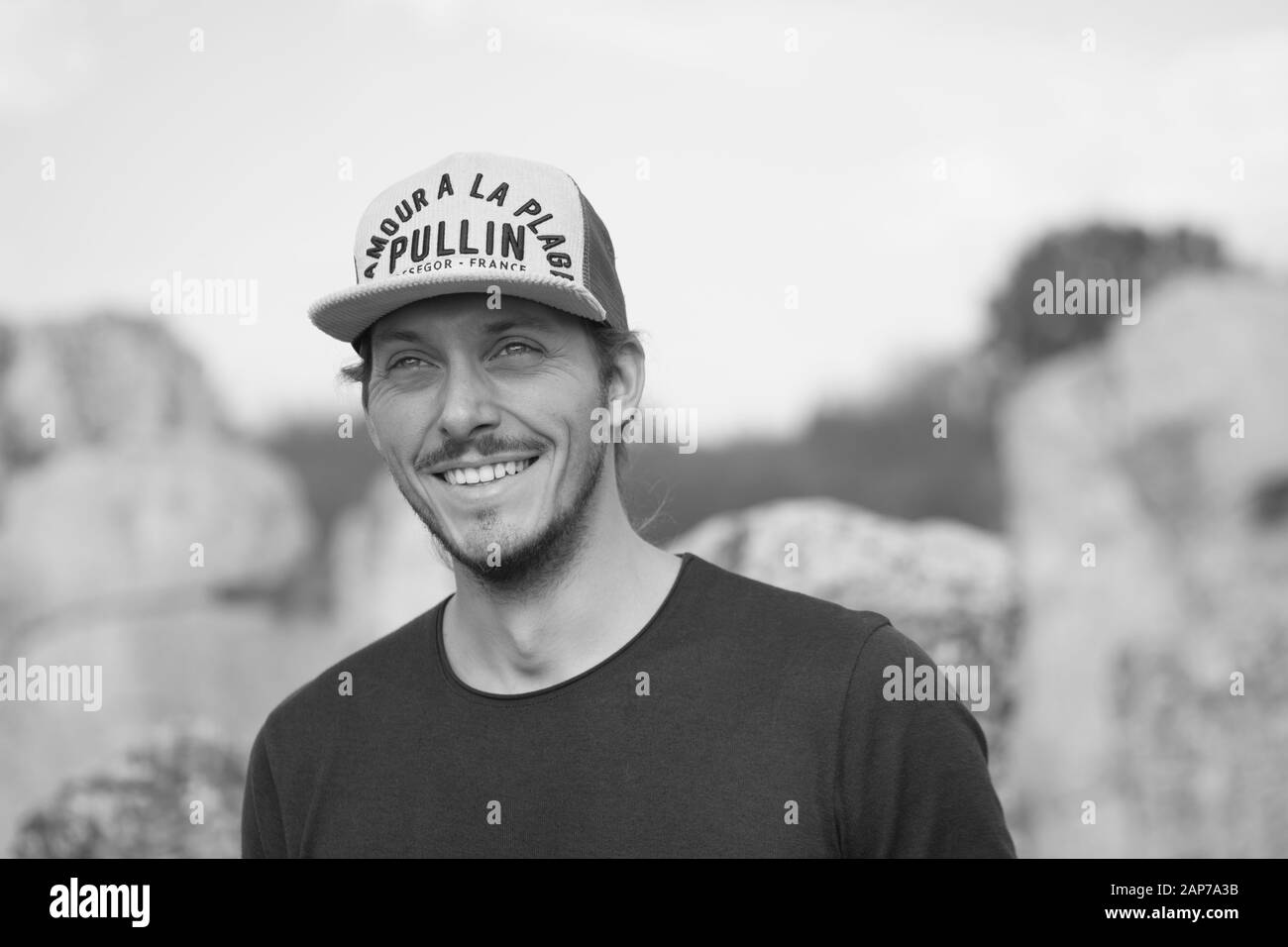 Men smiling with a hat in europe french text Stock Photo - Alamy