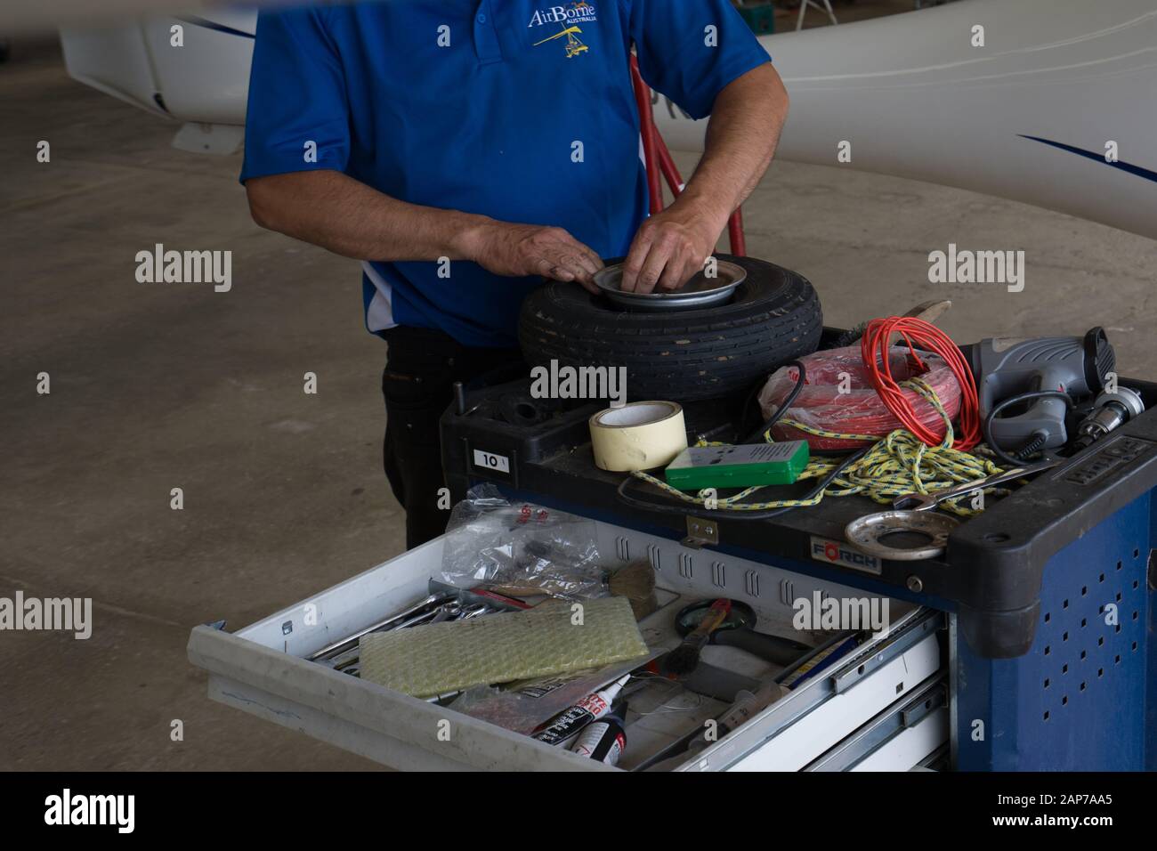 Microlight Ultralight aircraft changing flat tire Stock Photo - Alamy