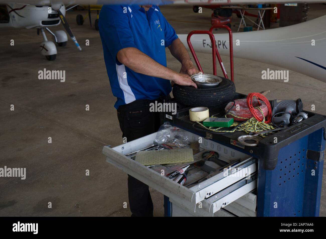 Microlight Ultralight aircraft changing flat tire Stock Photo - Alamy