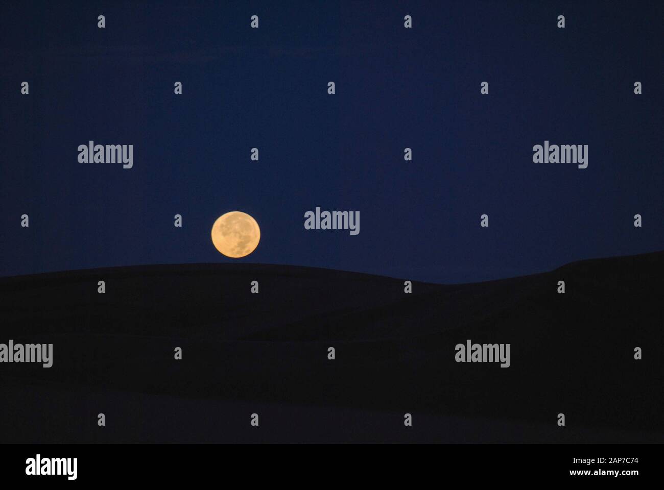 Moon rise over sand dunes Stock Photo - Alamy