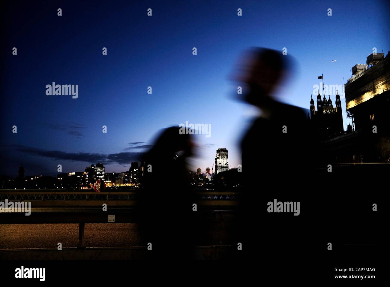 Commuters pedestrians walkers at dusk as shadows passing each other ...
