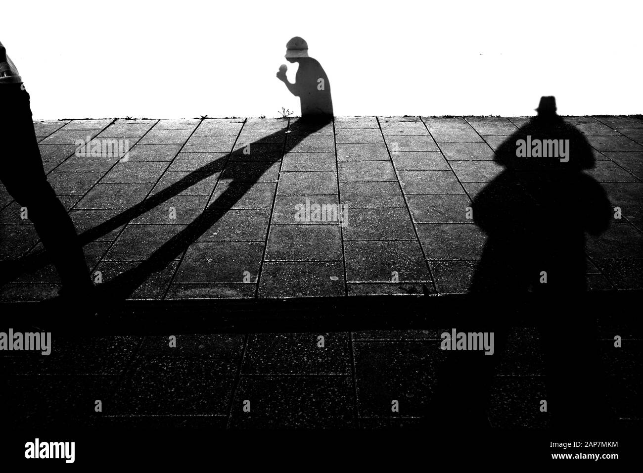 Long shadow of man walking on a white wall on the pavement shadow man ...