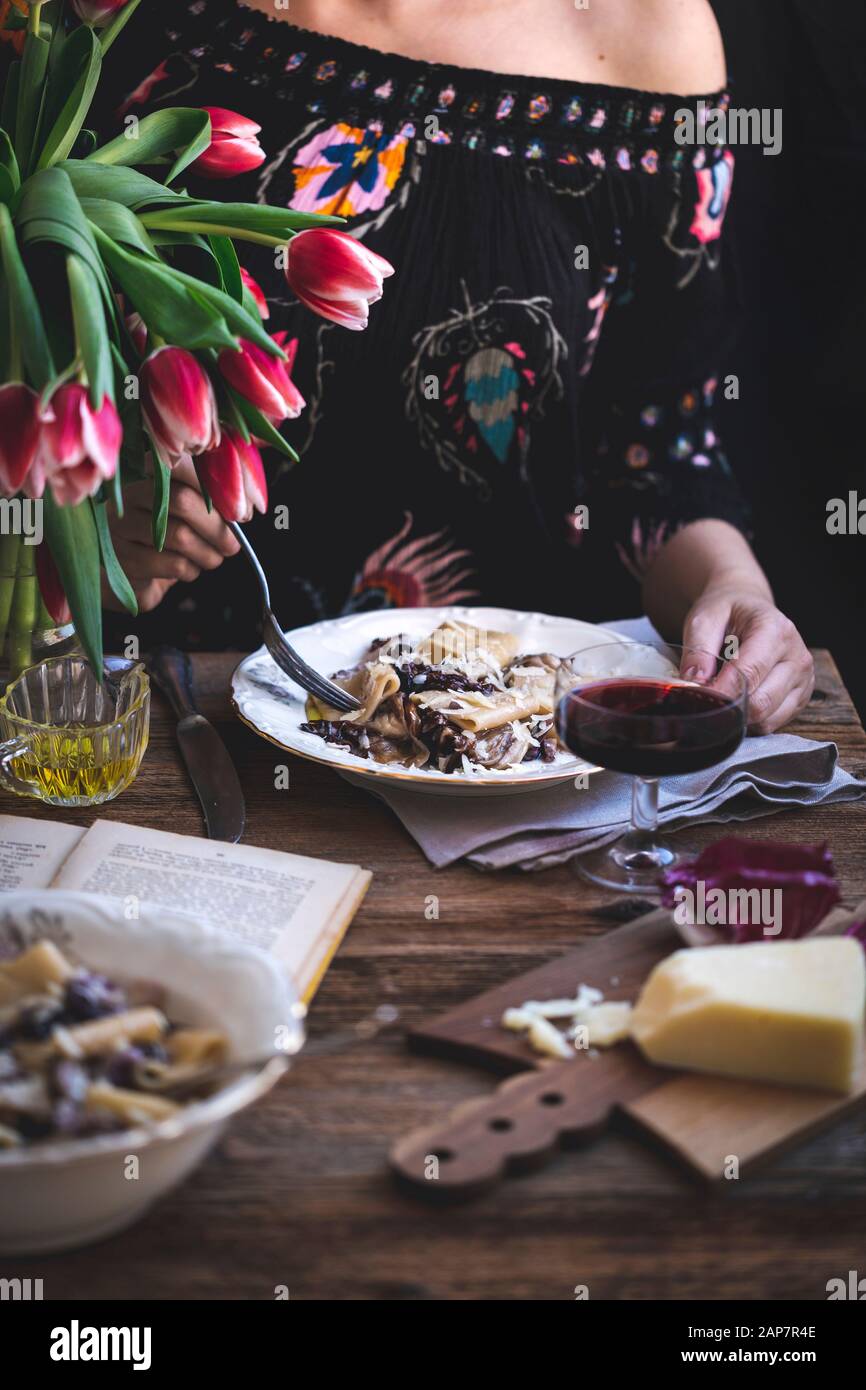 Woman eating pasta with radicchio, panceta and Parmesan Stock Photo - Alamy