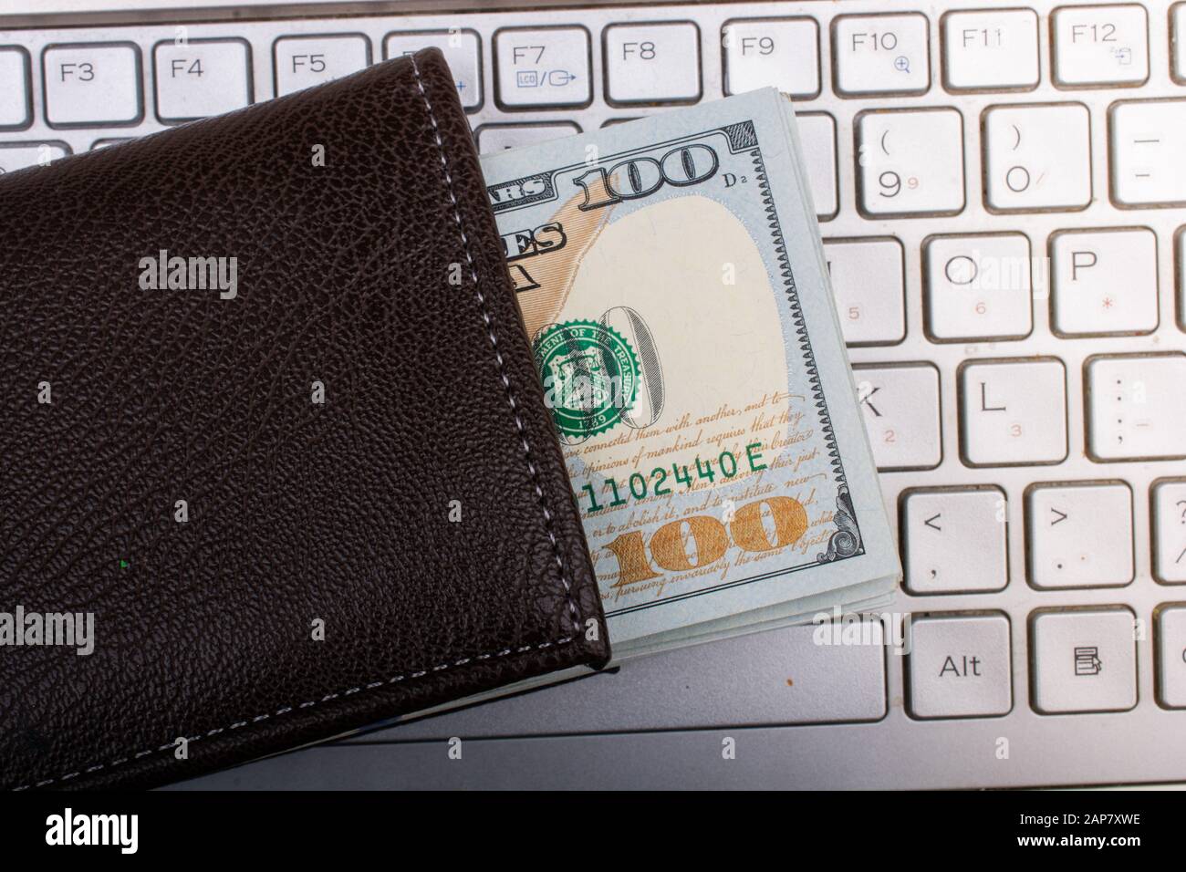 100 dollar bills on keyboard hi-res stock photography and images - Alamy