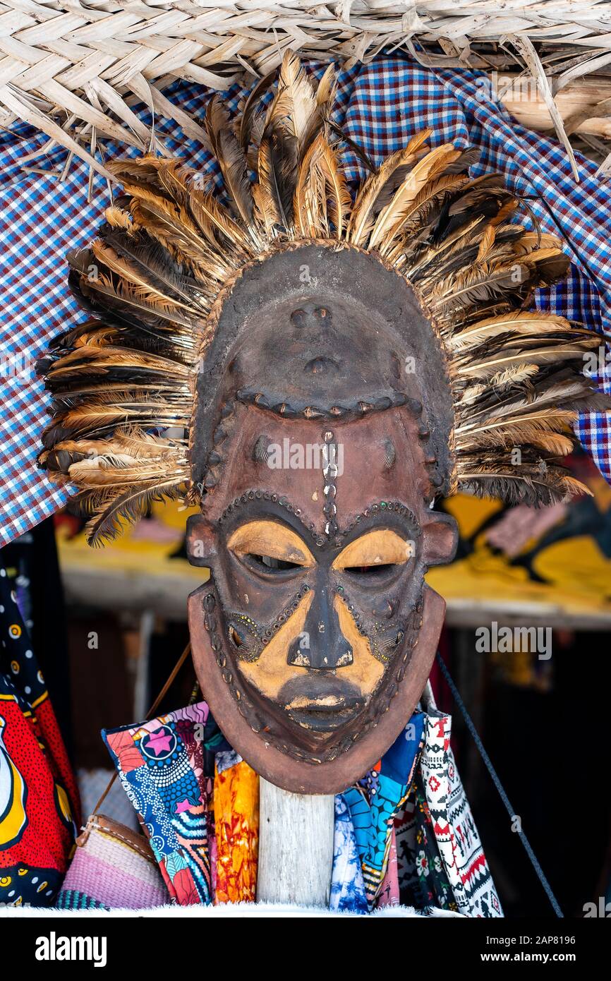 Traditional african wooden masks hanging for sell on the street market ...