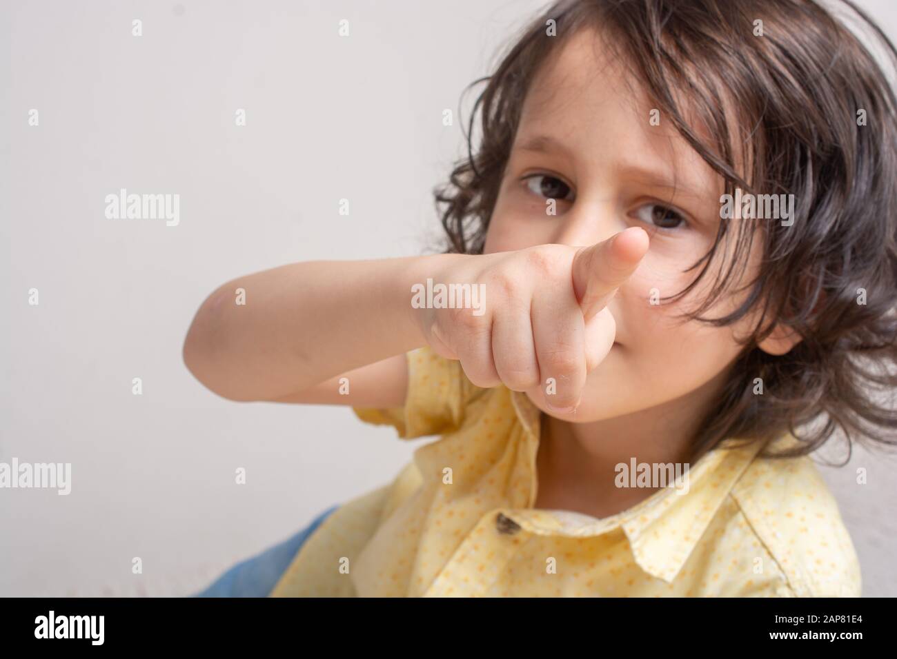 Sad kid boy pointing his finger away Stock Photo - Alamy