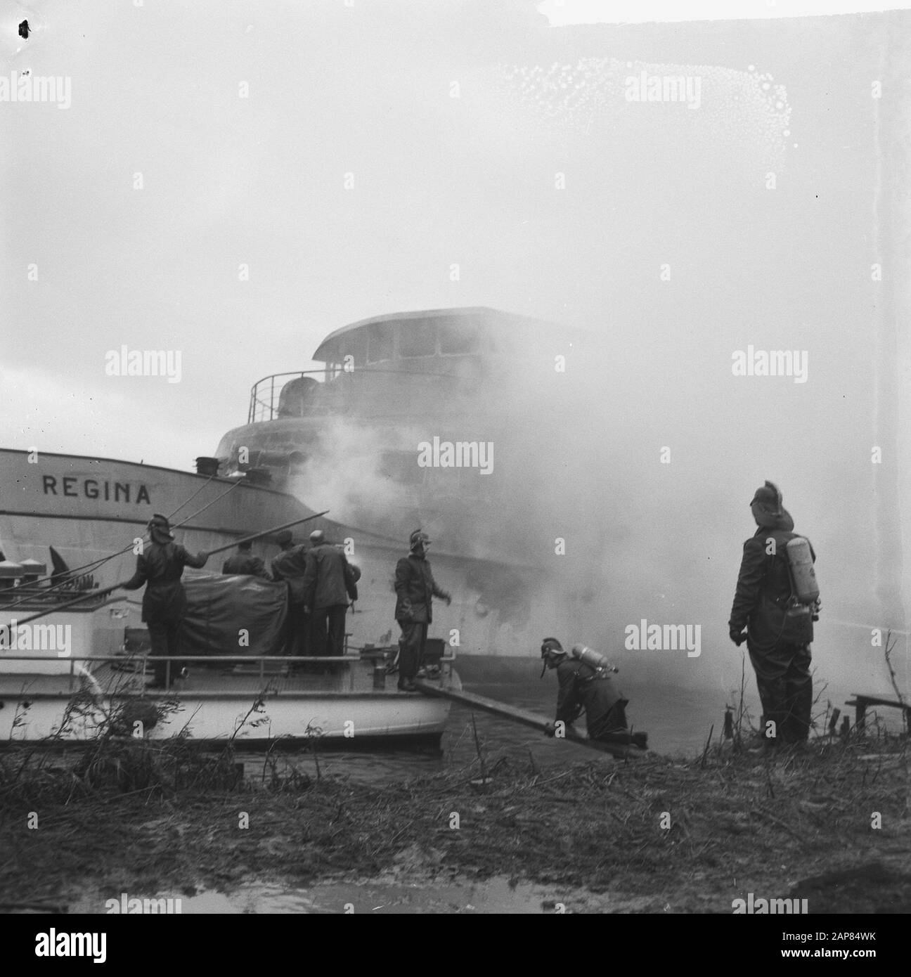 Fire brigade during the extinguishing of the passenger ship Regina near ...