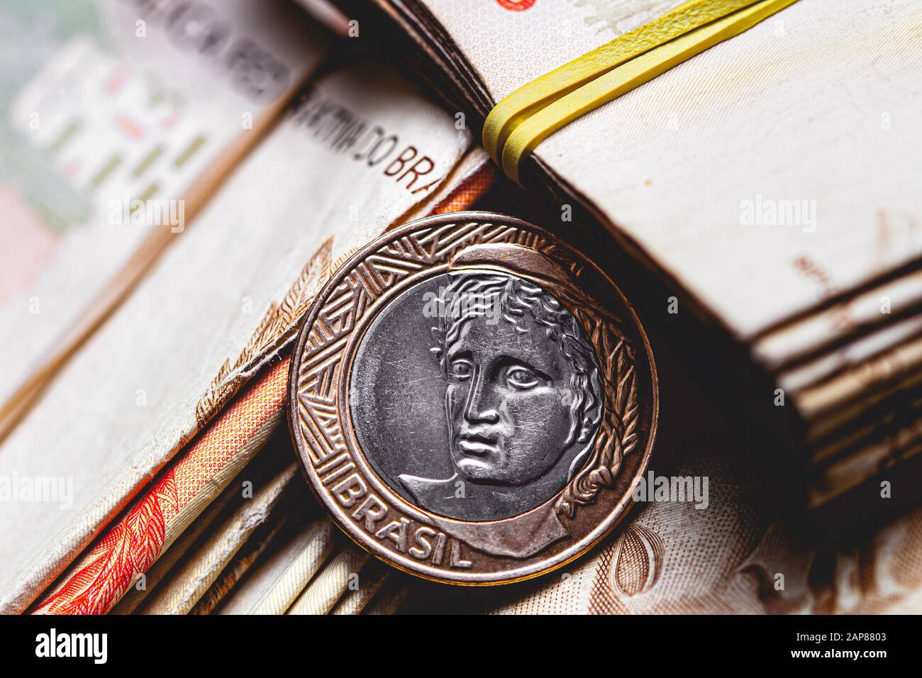 Brazilian Real - BRL. Photograph of a one Real coin over many money ...