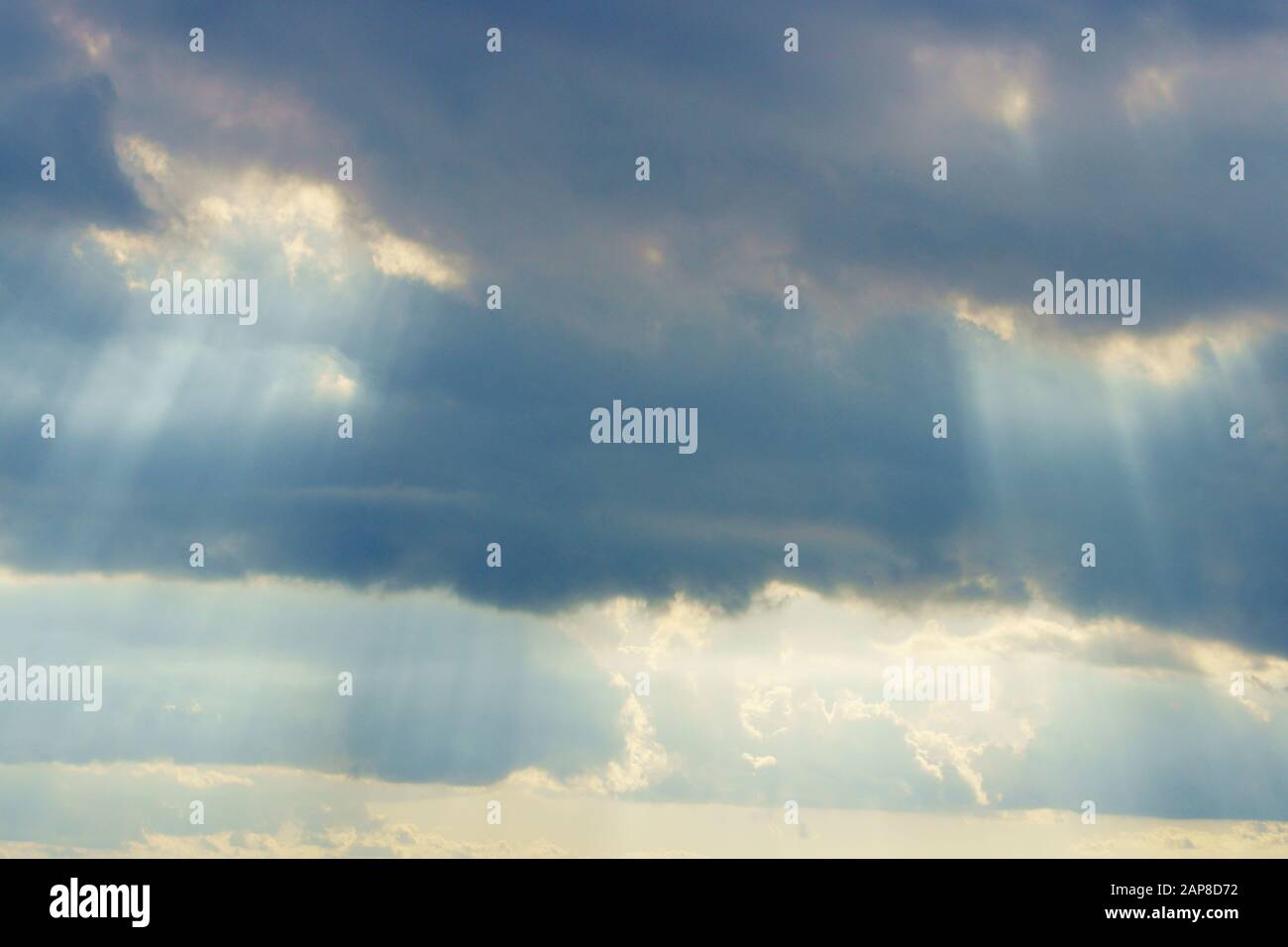 Sunlight through clouds Stock Photo - Alamy