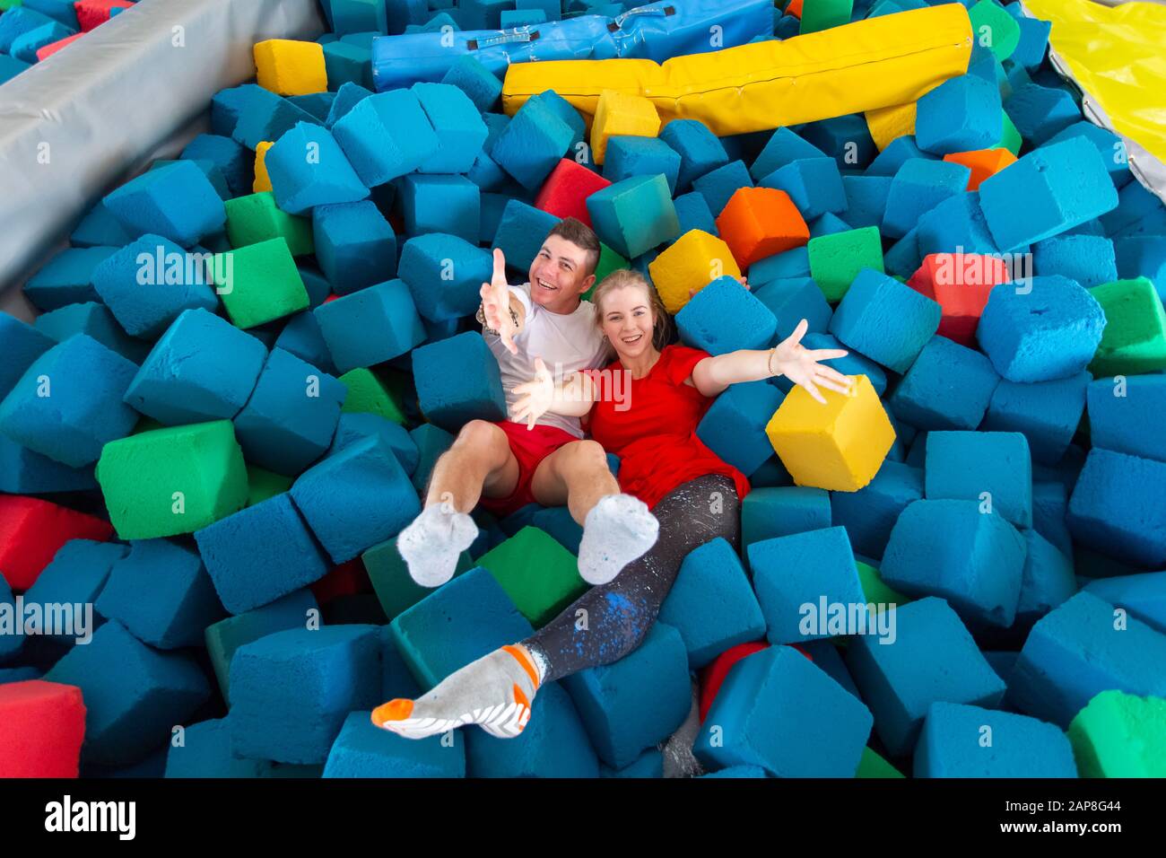 Funny happy man and woman having fun on a trampoline indoors Stock ...