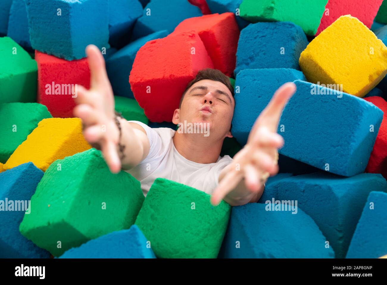 Funny happy man having fun on a trampoline indoors Stock Photo - Alamy