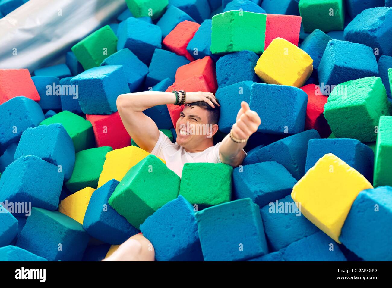 Funny happy man having fun on a trampoline indoors Stock Photo - Alamy