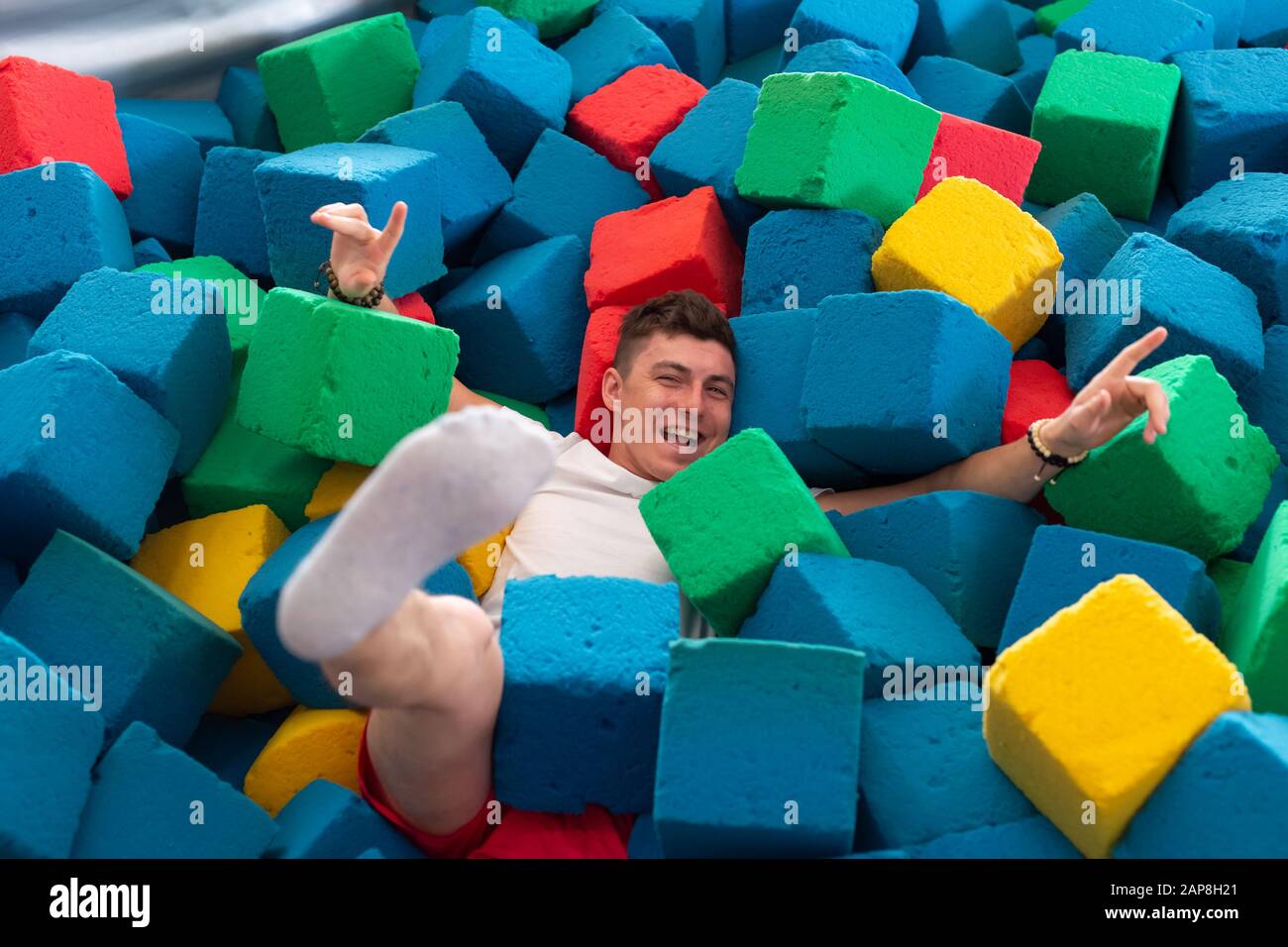 Funny happy man having fun on a trampoline indoors Stock Photo - Alamy