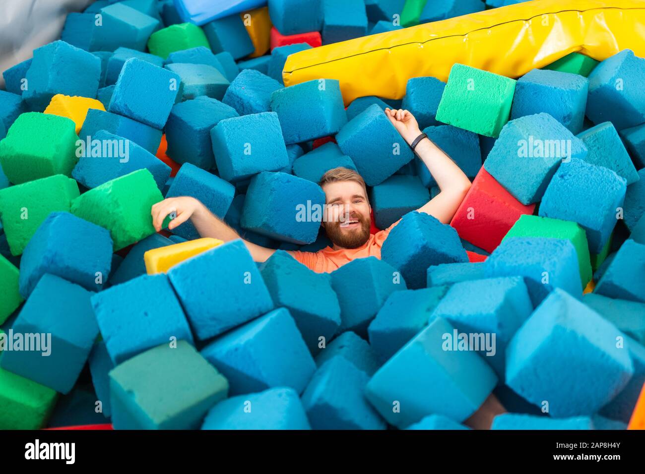 Funny happy man having fun on a trampoline indoors Stock Photo - Alamy