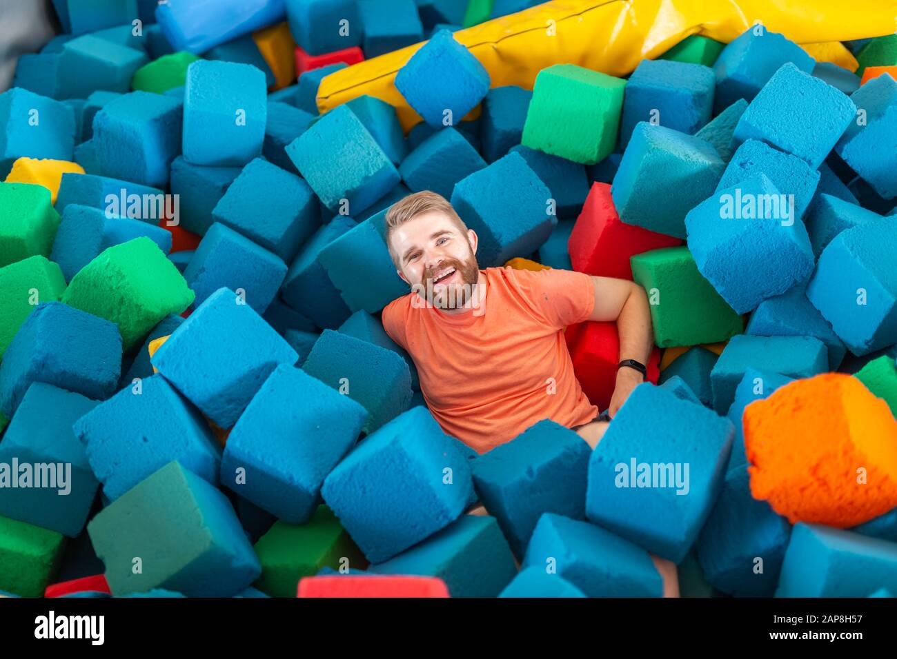 Funny happy man having fun on a trampoline indoors Stock Photo - Alamy
