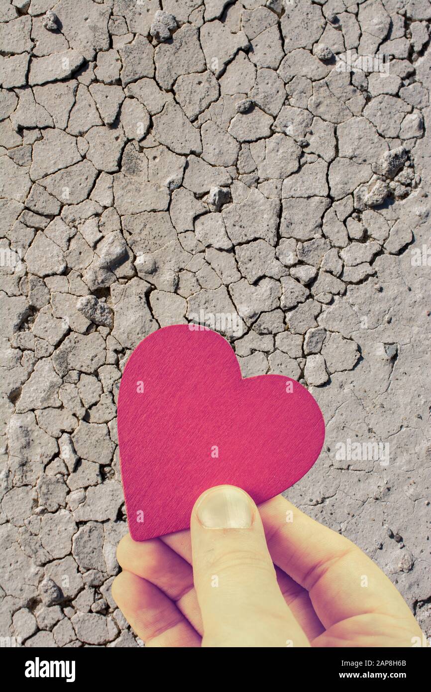 Red heart shaped object in hand as love concept Stock Photo - Alamy