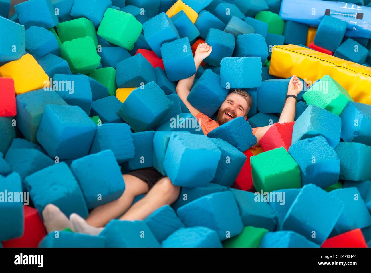 Funny happy man having fun on a trampoline indoors Stock Photo - Alamy
