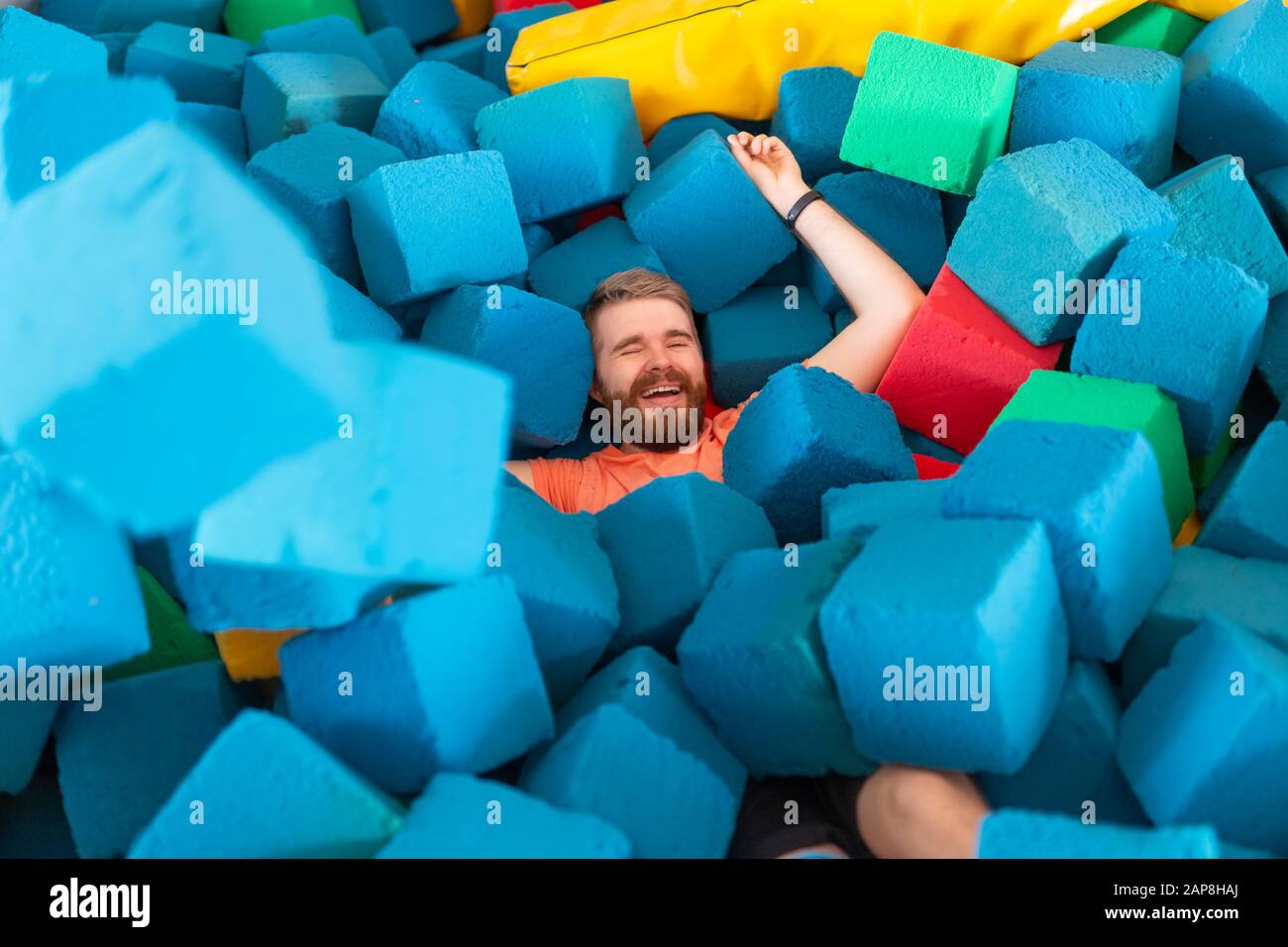 Funny happy man having fun on a trampoline indoors Stock Photo - Alamy