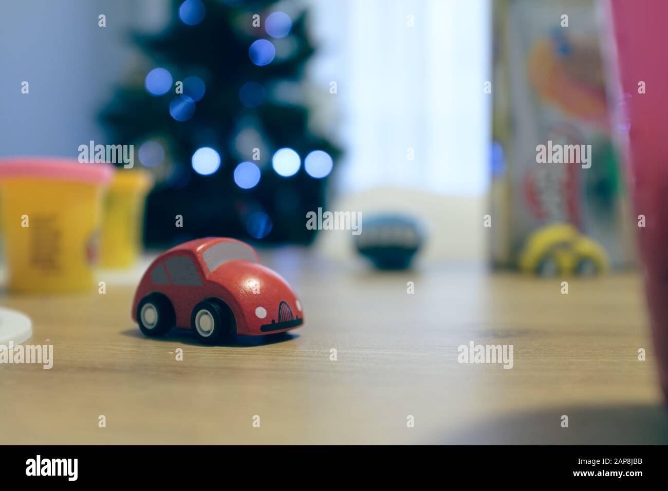 Red toy tiny racing car on a Christmas indoor background Stock Photo ...