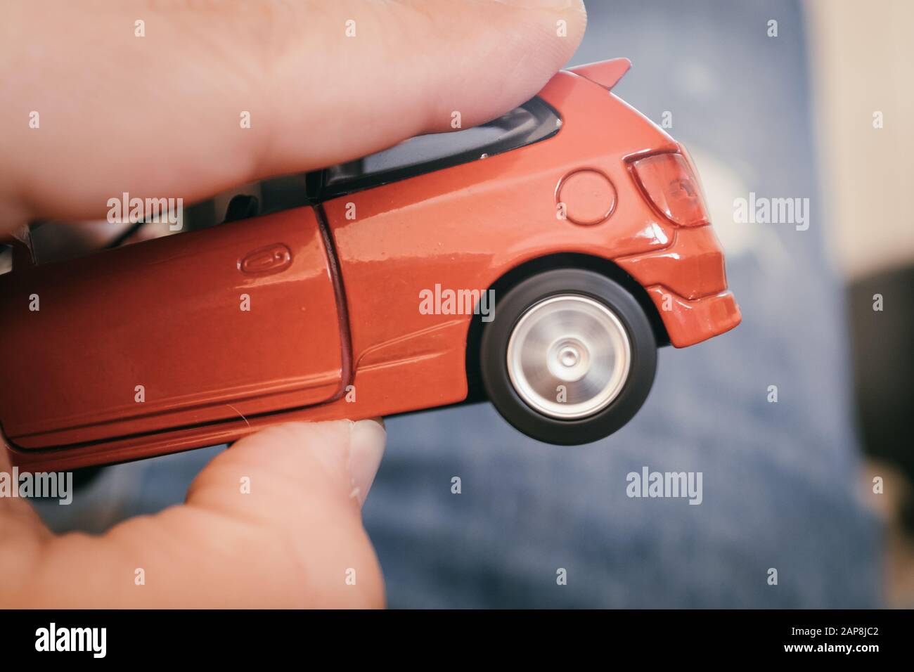 Spinning wheel on a red toy car Stock Photo - Alamy