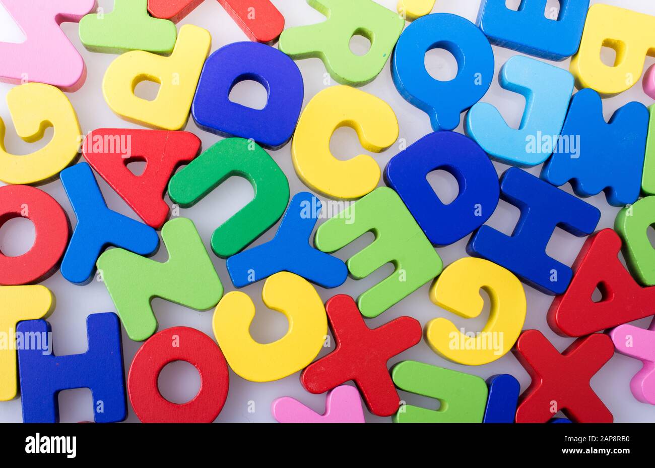 Colorful alphabet letter blocks scattered randomly on white background ...