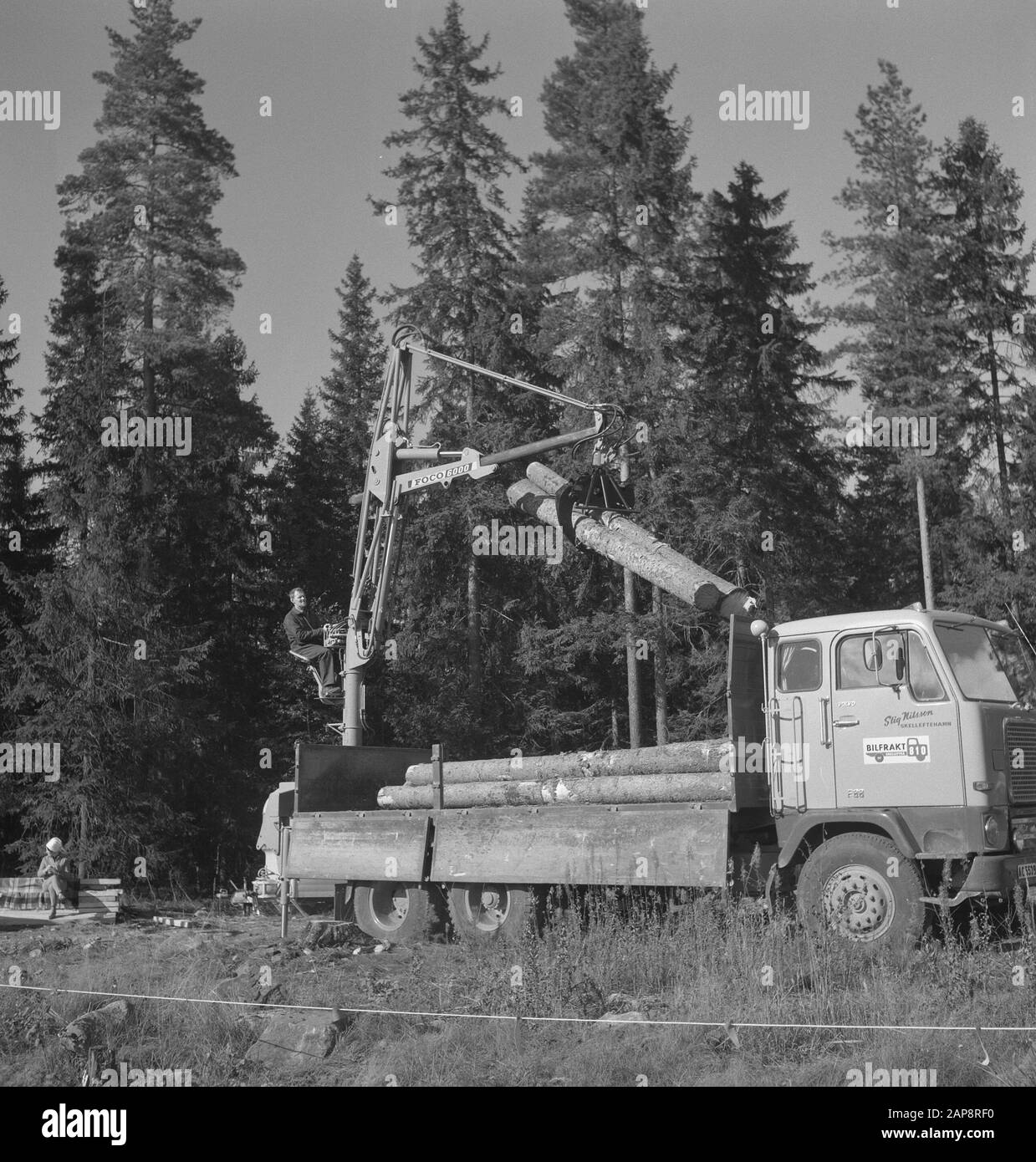 forestry, tow trucks, tree trunks, workers, hoist work Date: undated ...