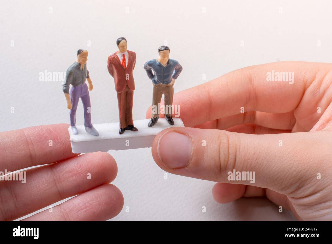 Tiny figurines of men miniature model in hand Stock Photo - Alamy