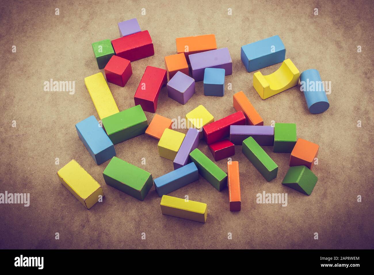 Colorful building blocks on a brown background Stock Photo - Alamy