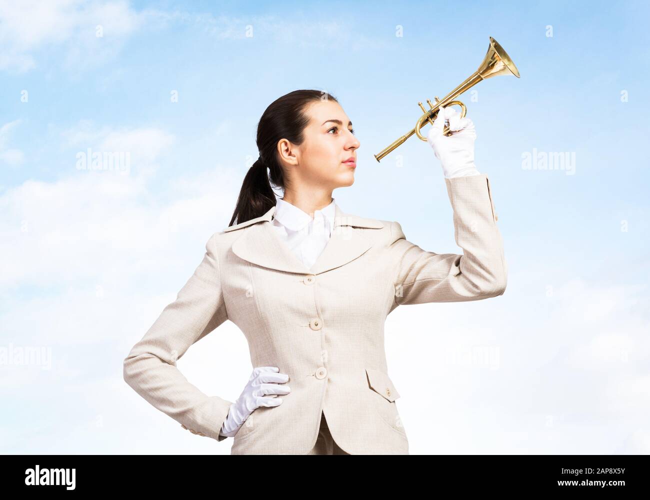 Beautiful woman playing trumpet brass Stock Photo - Alamy