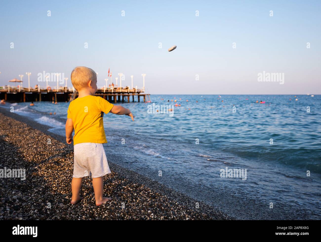 Boy throwing stone sea hi-res stock photography and images - Alamy