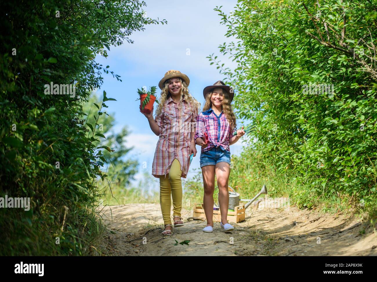Girls with gardening tools. Agriculture concept. Adorable girls in hats ...