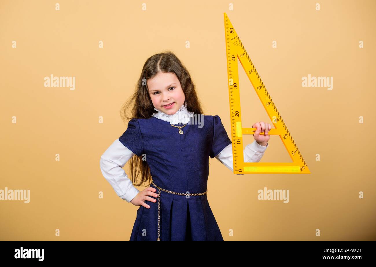 Girl with big ruler. School student study geometry. Kid school uniform ...