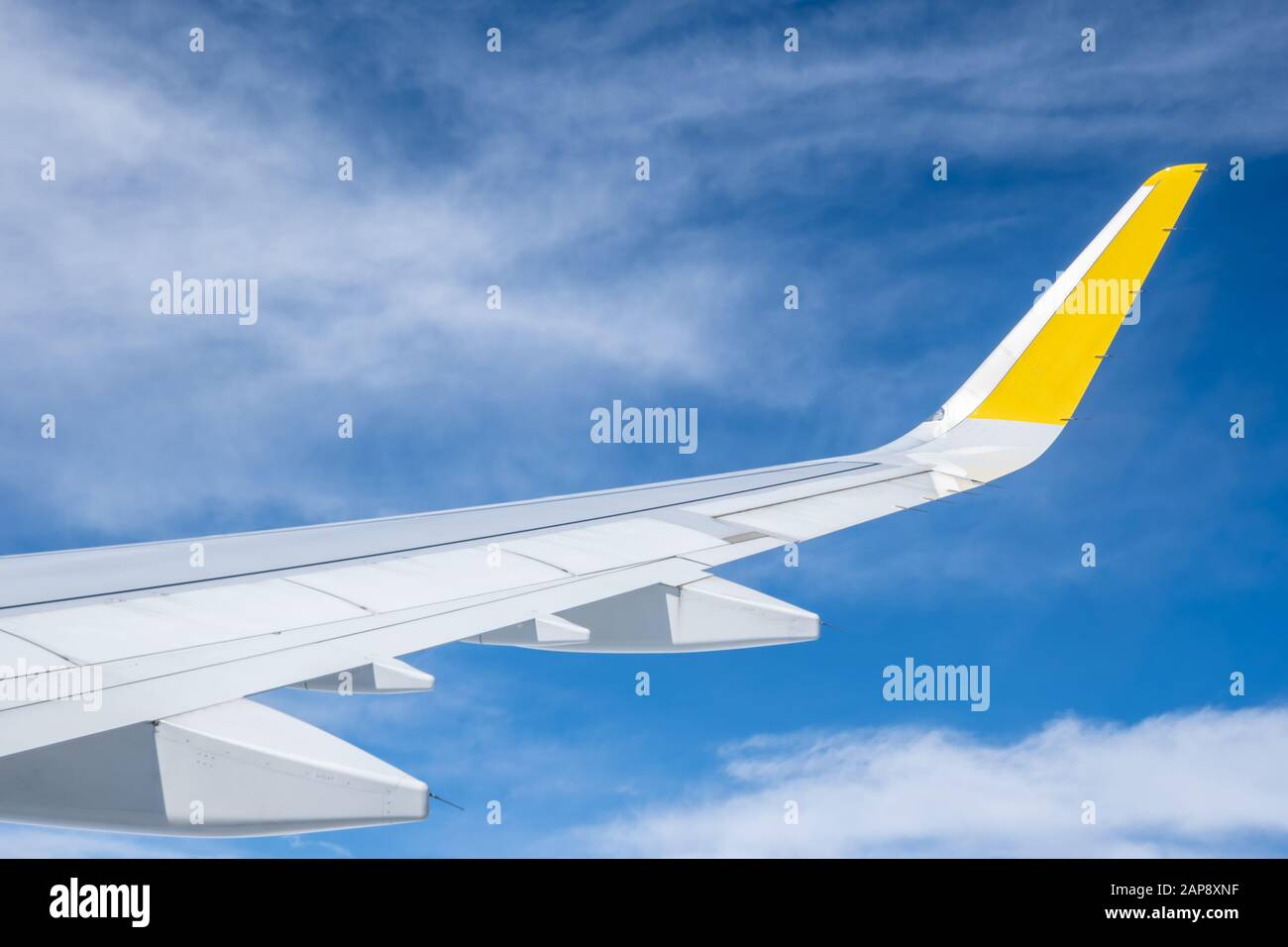 White plane wing with a cloudy background Stock Photo - Alamy