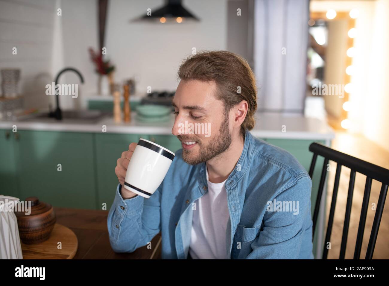 Handsome man having his morning cup of tea Stock Photo - Alamy