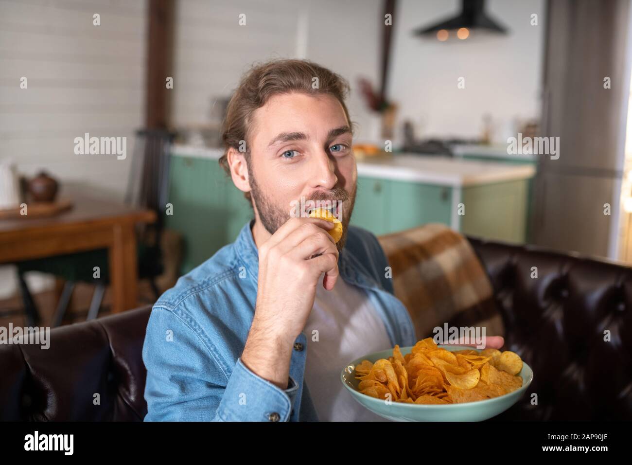 Man eating chips watching football hi-res stock photography and images ...