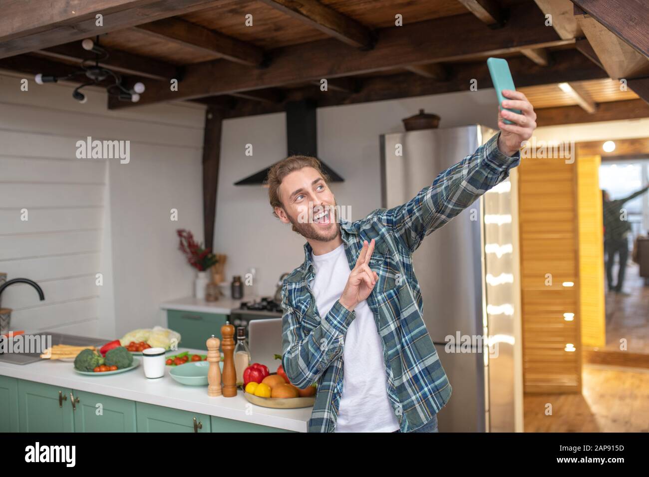 Young man making selfie in the kitchen Stock Photo - Alamy