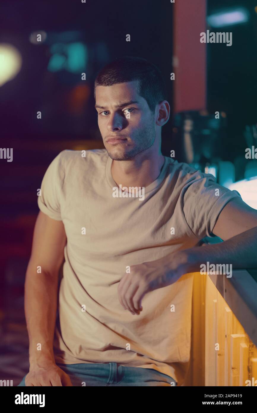 Close-up portrait of attractive male model. Retro wave portrait of a ...