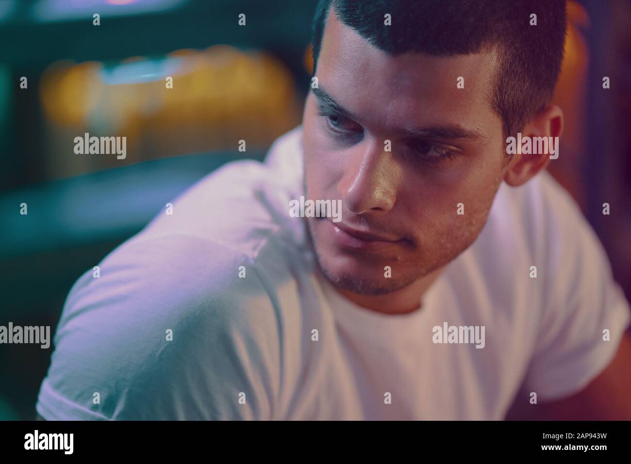 Close-up portrait of attractive male model. Retro wave portrait of a ...