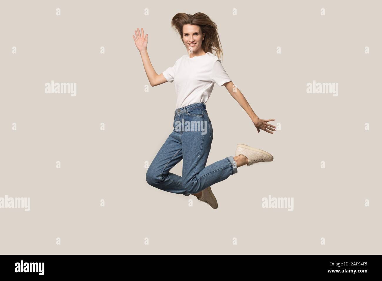 Active young woman jump high posing in studio Stock Photo - Alamy
