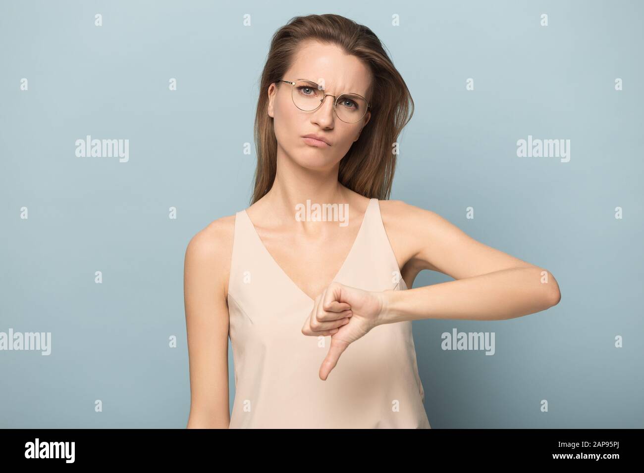 Disappointed woman in glasses show thumb down feel dissatisfied Stock ...